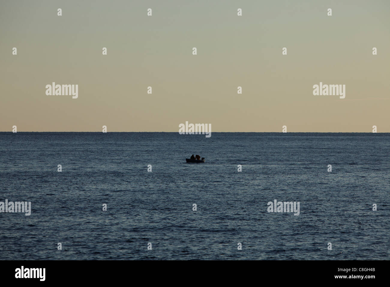 Isolated rowing boat out at sea Stock Photo - Alamy