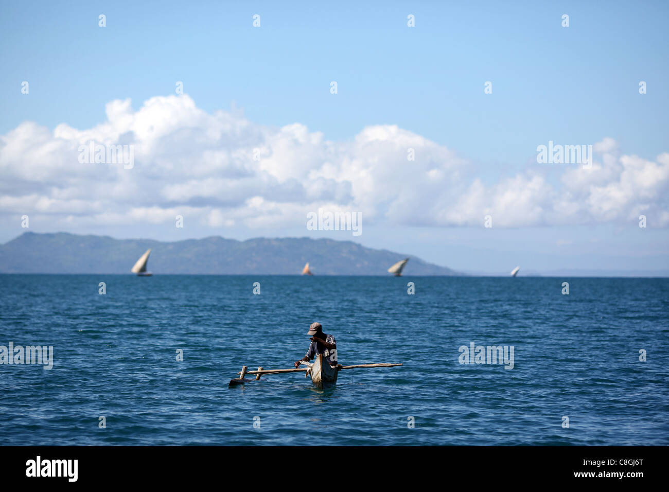 A fisherman line fishing from a traditional malagasy pirogue (outrigger ...