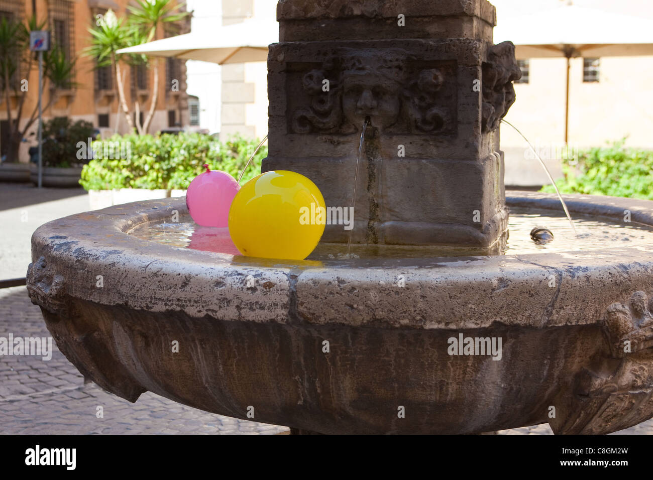 Balloons floating in a fountain in the backstreets of Rome Italy Stock ...