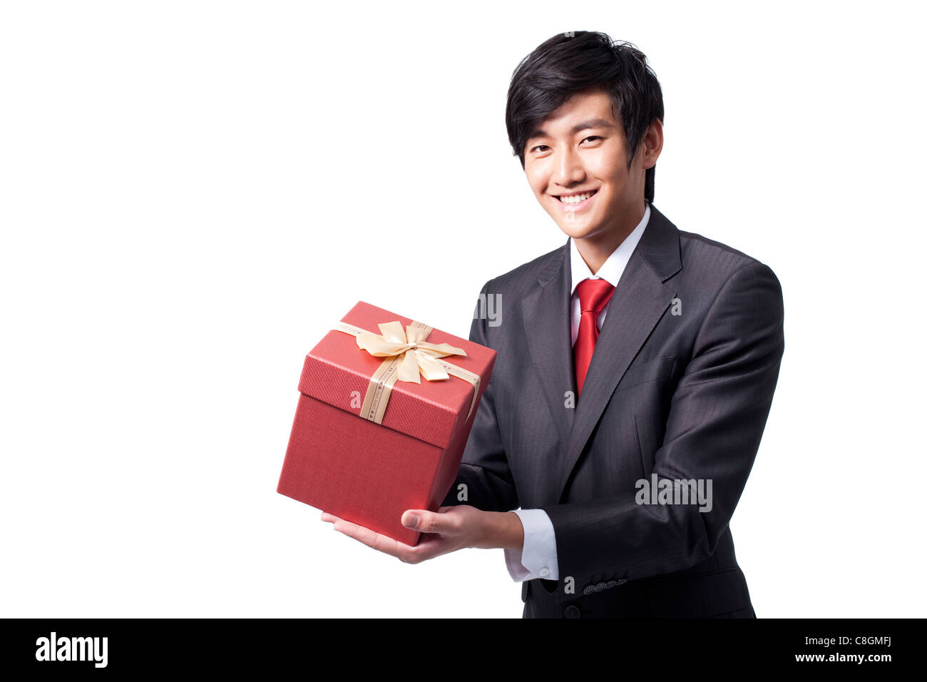 Happy Businessman Holding a Gift Stock Photo - Alamy