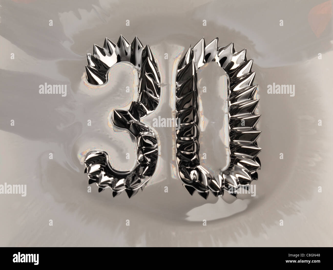 The number 30 thirty shown in ferro magnetic liquid Stock Photo - Alamy
