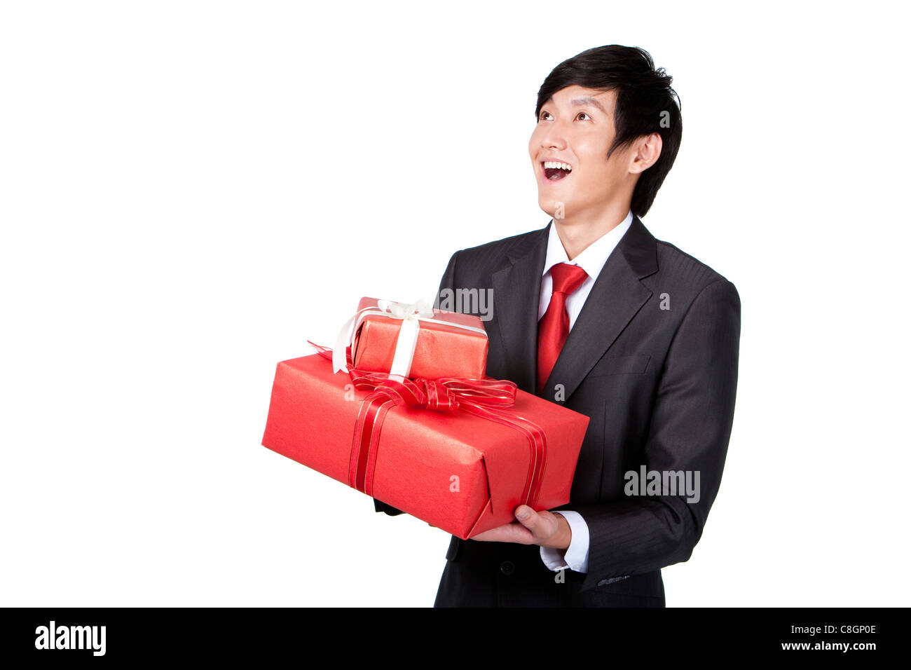 Excited Businessman Holding Gifts Stock Photo - Alamy
