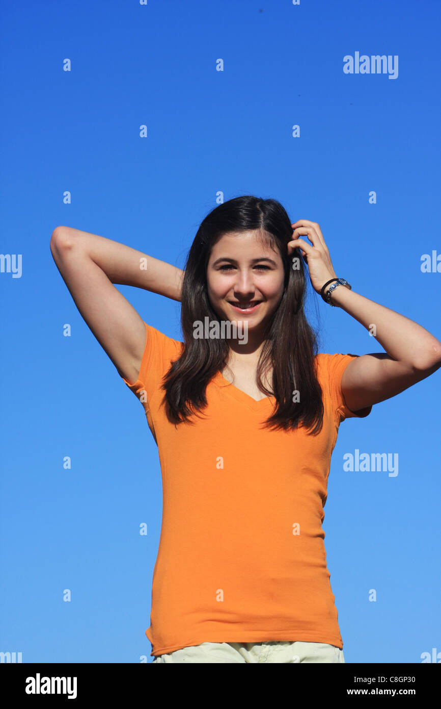 Girls, teenagers, brown, hair, portrait, orange, blue Stock Photo - Alamy