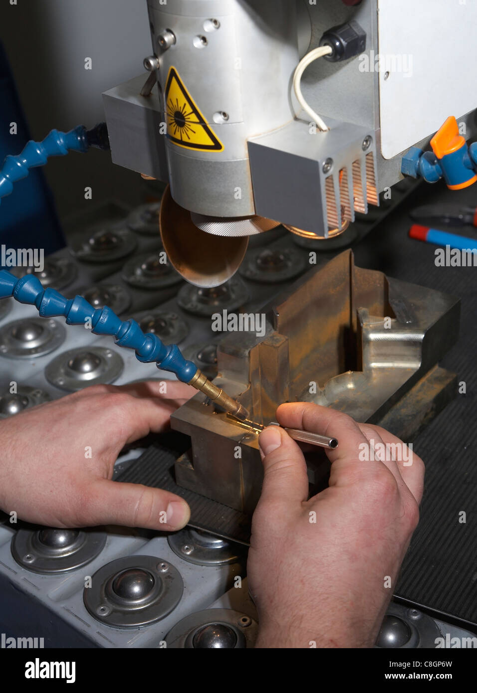 detail of a laser welding workplace with hands and workpiece Stock ...