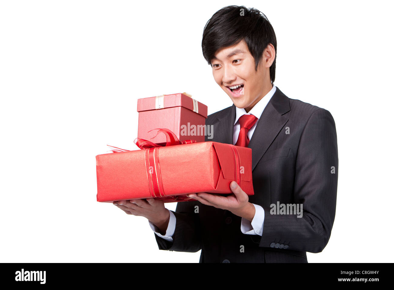 Excited Businessman Holding Gifts Stock Photo - Alamy