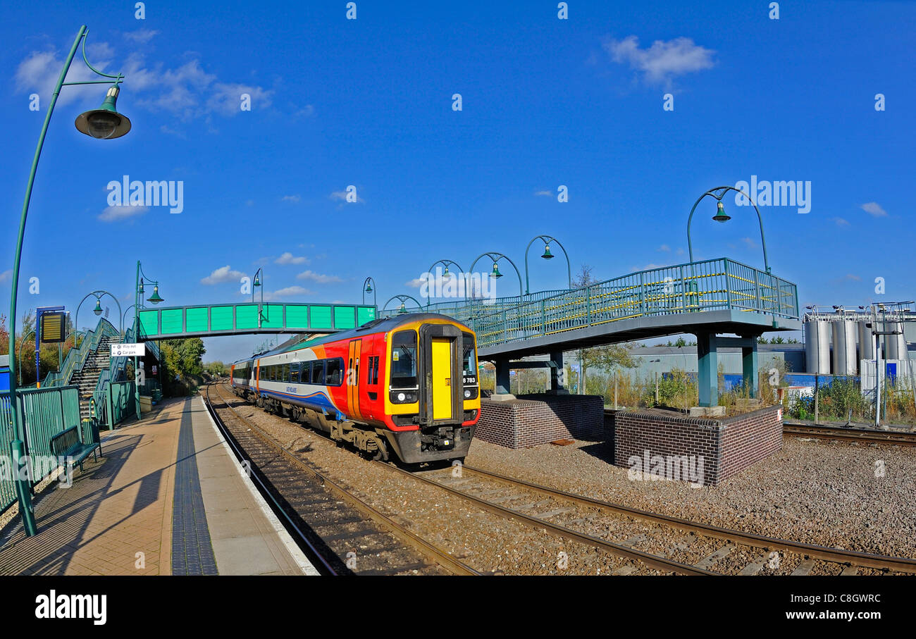 Commuter train pulling out of the local train station Stock Photo - Alamy