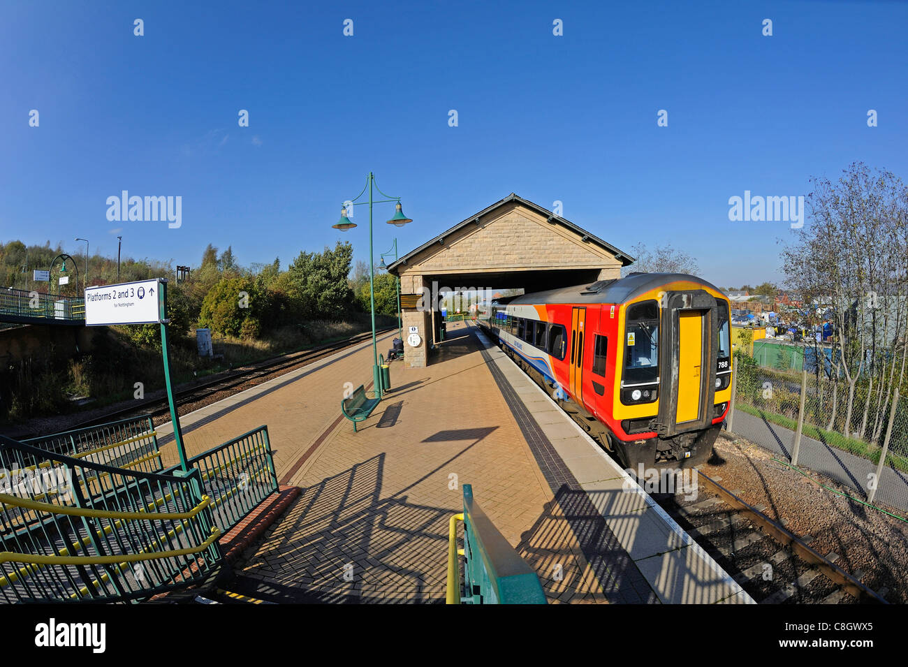Commuter train pulling out of the local train station Stock Photo - Alamy
