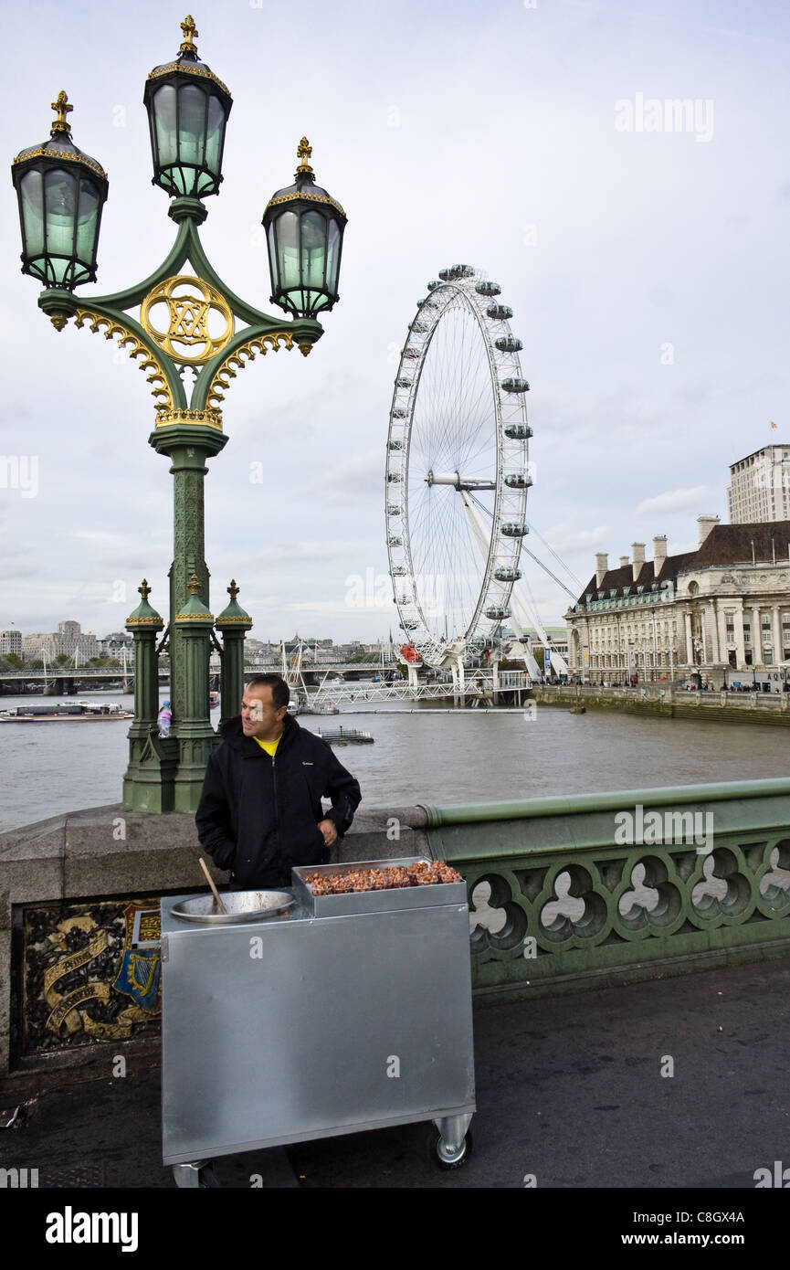 Street vendor selling hot nuts on Westminster Bridge in London, October ...