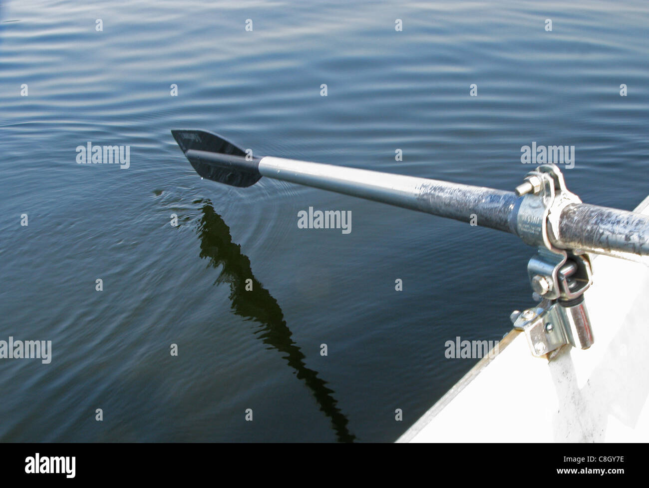 A oar of a row boat slightly above the water's surface Stock Photo - Alamy