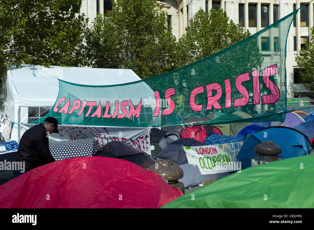Tents with slogans, posters and banners at the anti Capitalist protest ...