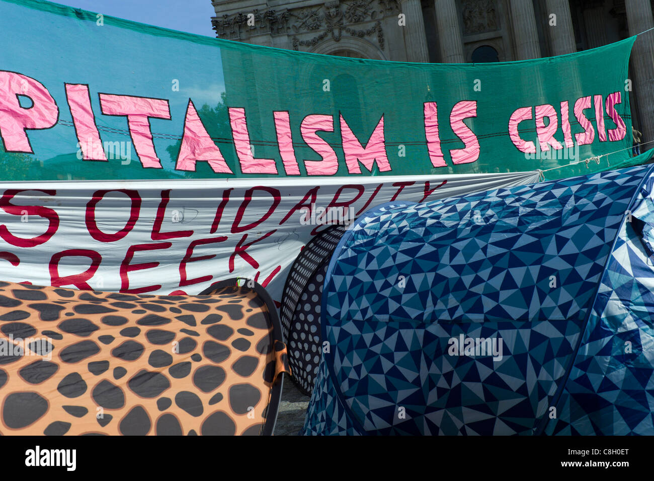 Tents with slogans, posters and banners at the anti Capitalist protest ...