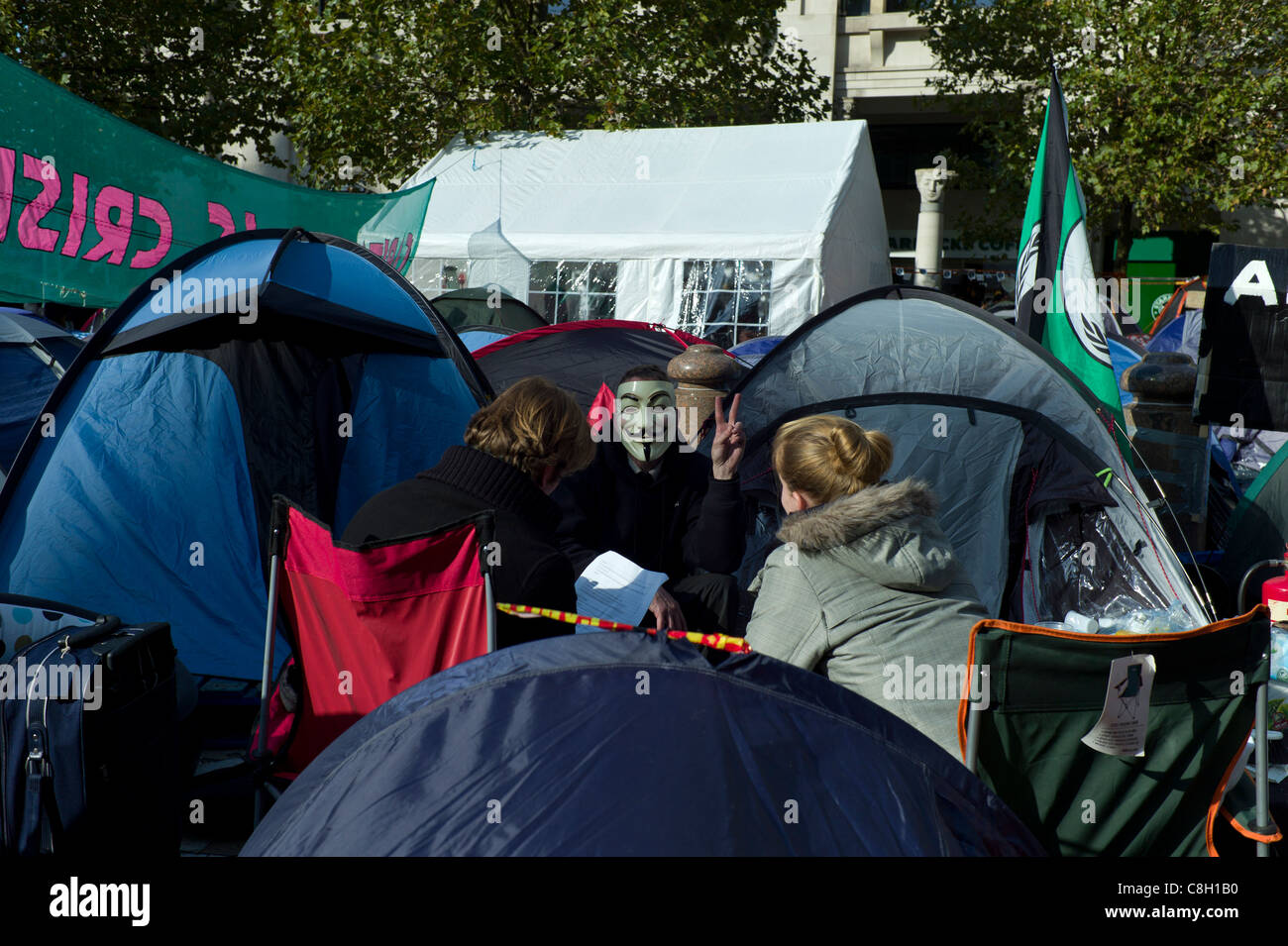 Protesters and tents with slogans and banners at the anti Capitalist ...