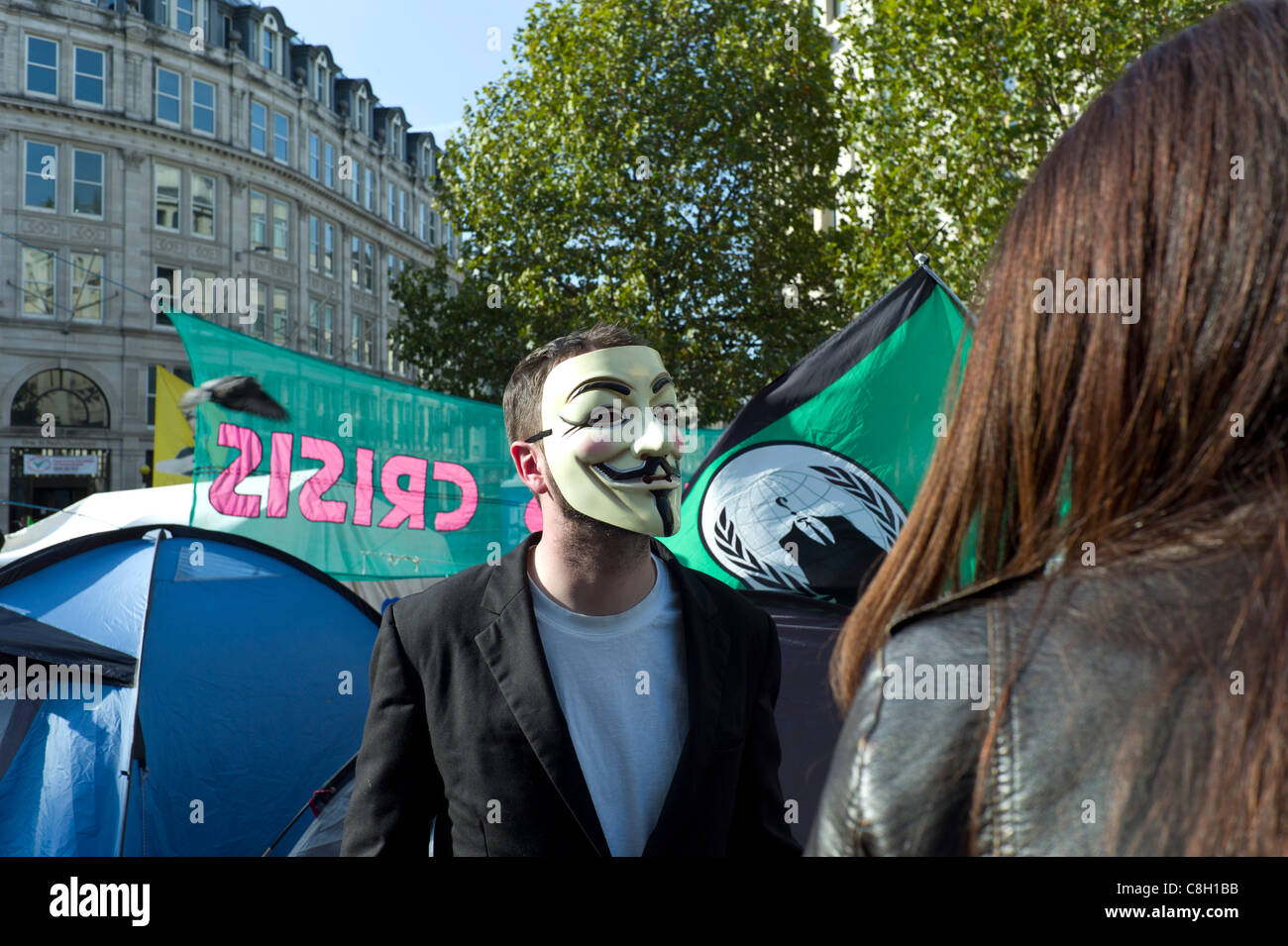 Protesters and tents with slogans and banners at the anti Capitalist ...