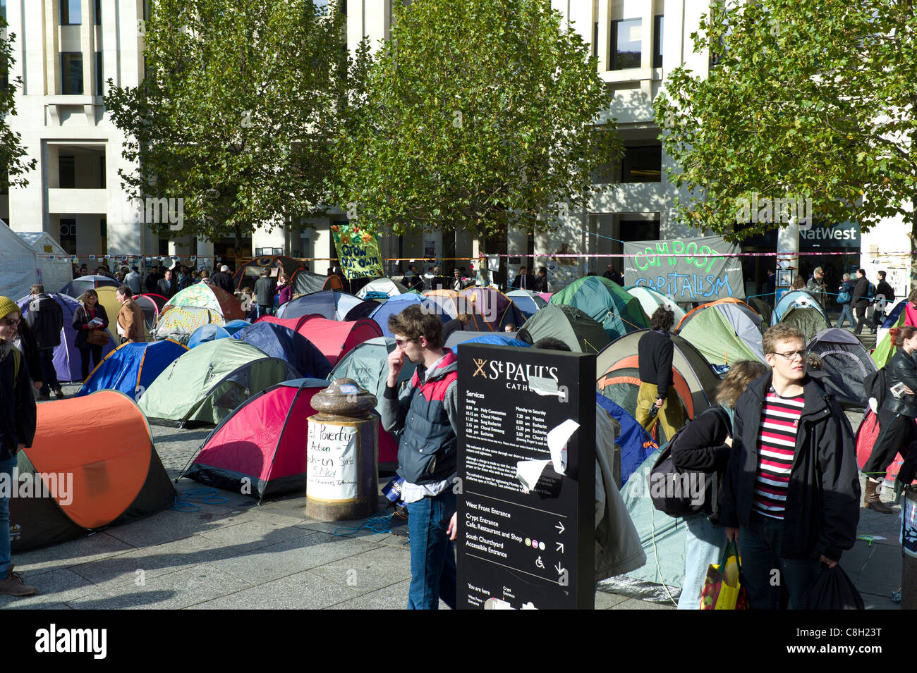 Protesters and tents with slogans and banners at the anti Capitalist ...