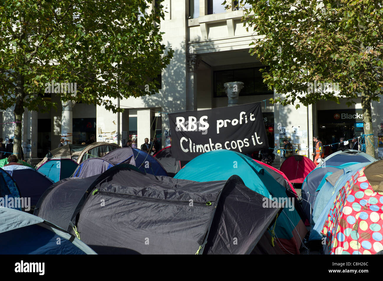 Protesters and tents with slogans and banners at the anti Capitalist ...