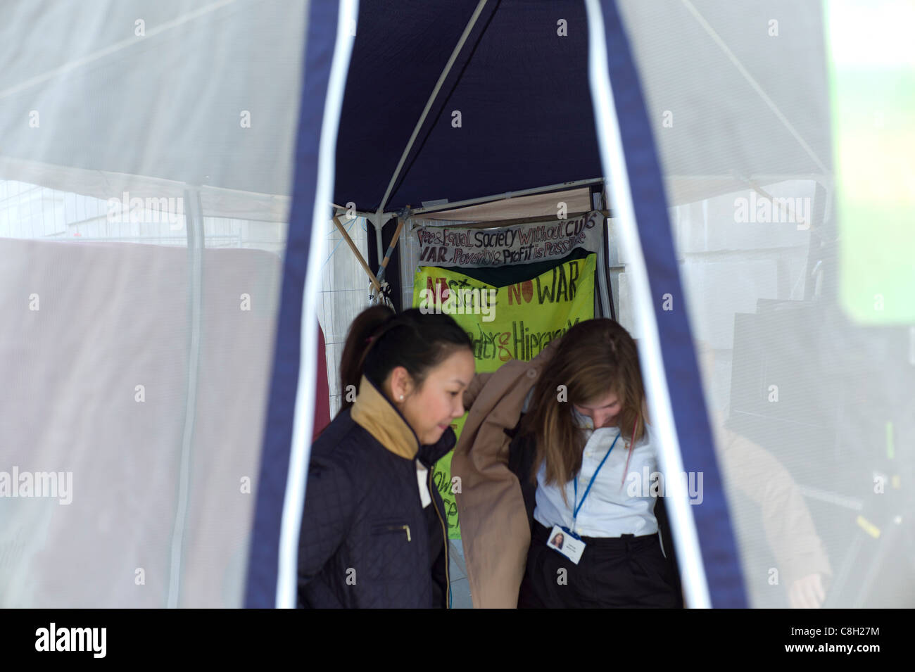 Protesters and tents with slogans and banners at the anti Capitalist ...