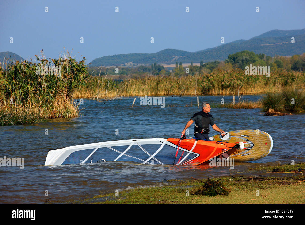 A windsurfer coming out of lake Volvi, a few kilometers east of ...