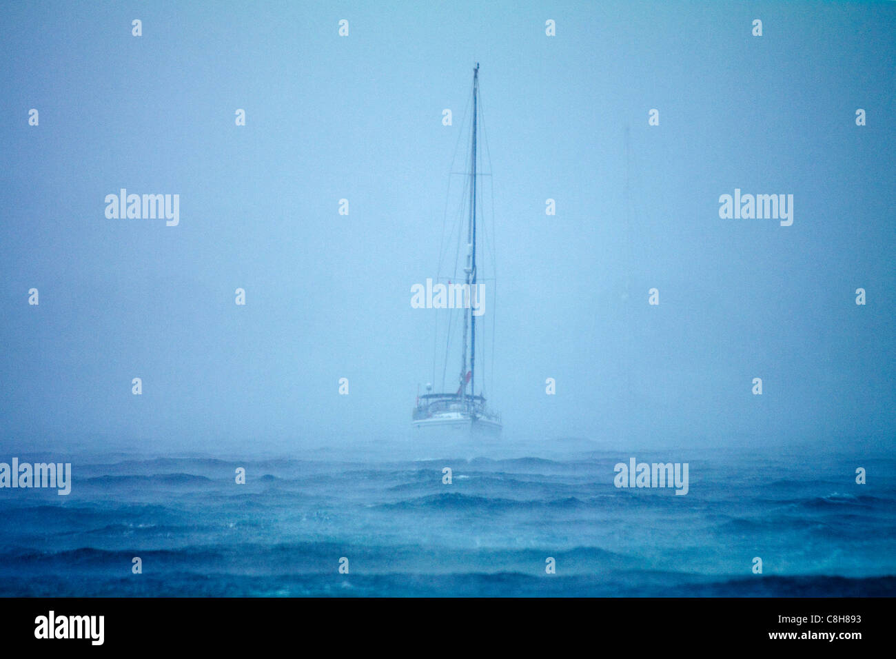 A tropical storm engulfs an ocean yacht with gale force wind and rain ...
