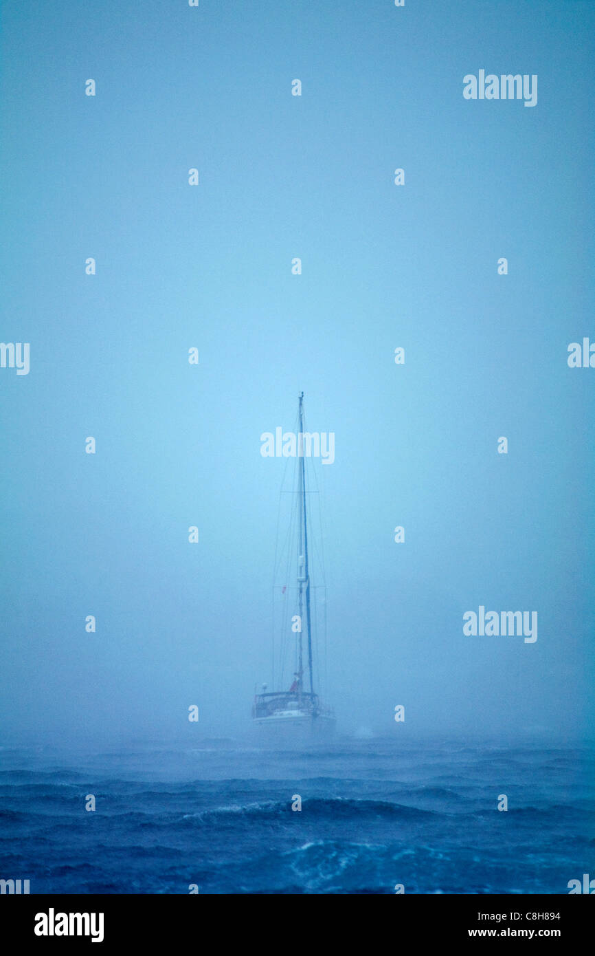 A tropical storm engulfs an ocean yacht with gale force wind and rain ...