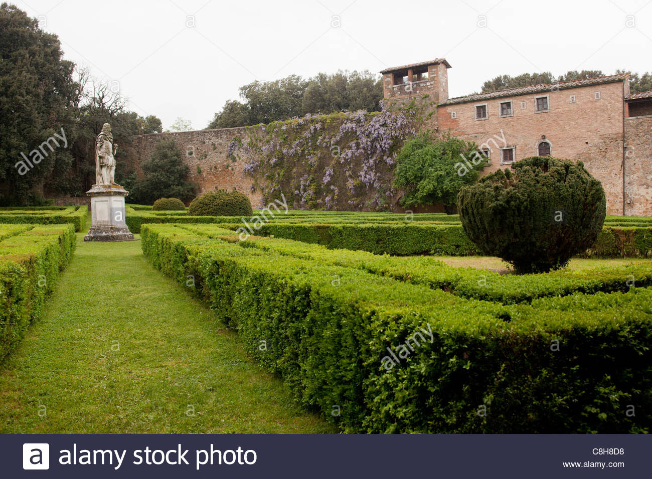 A statue sits in a sculptured garden in a Tuscan village Stock Photo ...