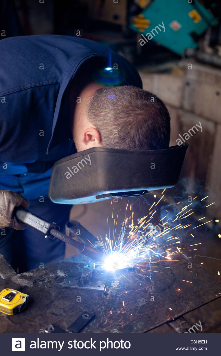 A Blacksmith welding Stock Photo - Alamy