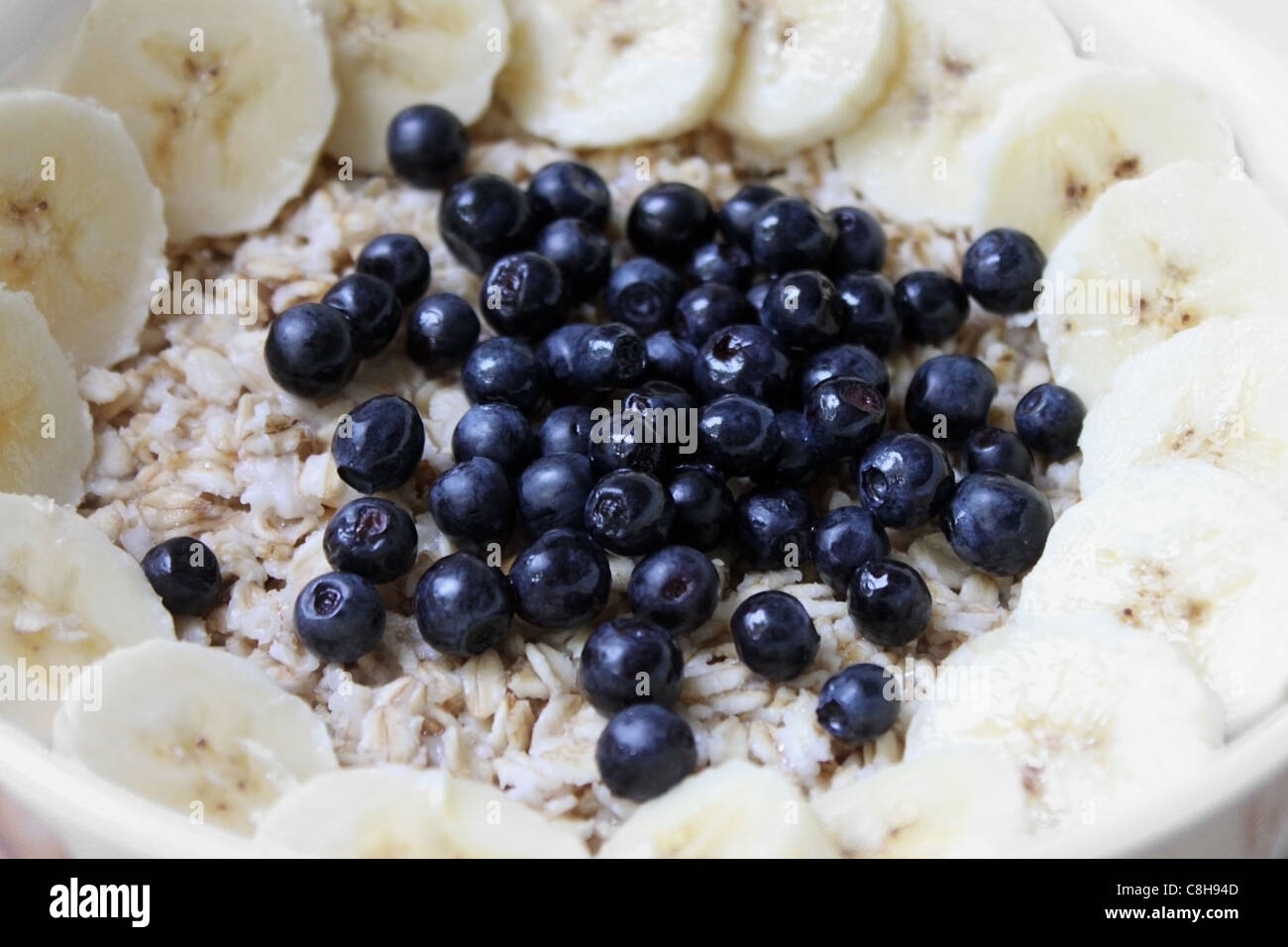 Porridge with berries and bananas Stock Photo - Alamy