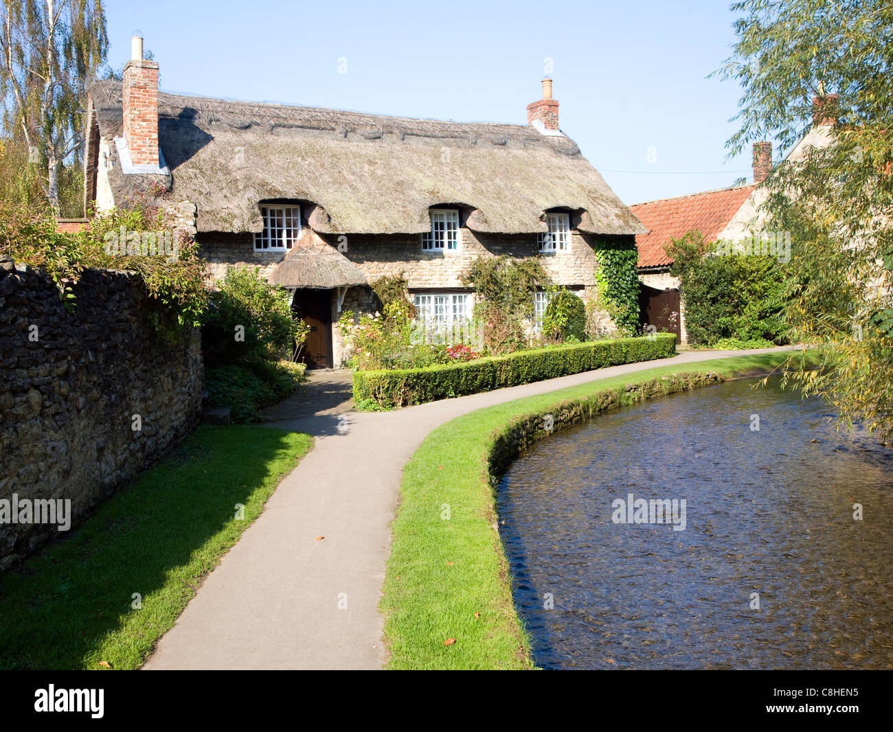 Thatched cottage by stream, Thornton le Dale, Yorkshire, England Stock ...