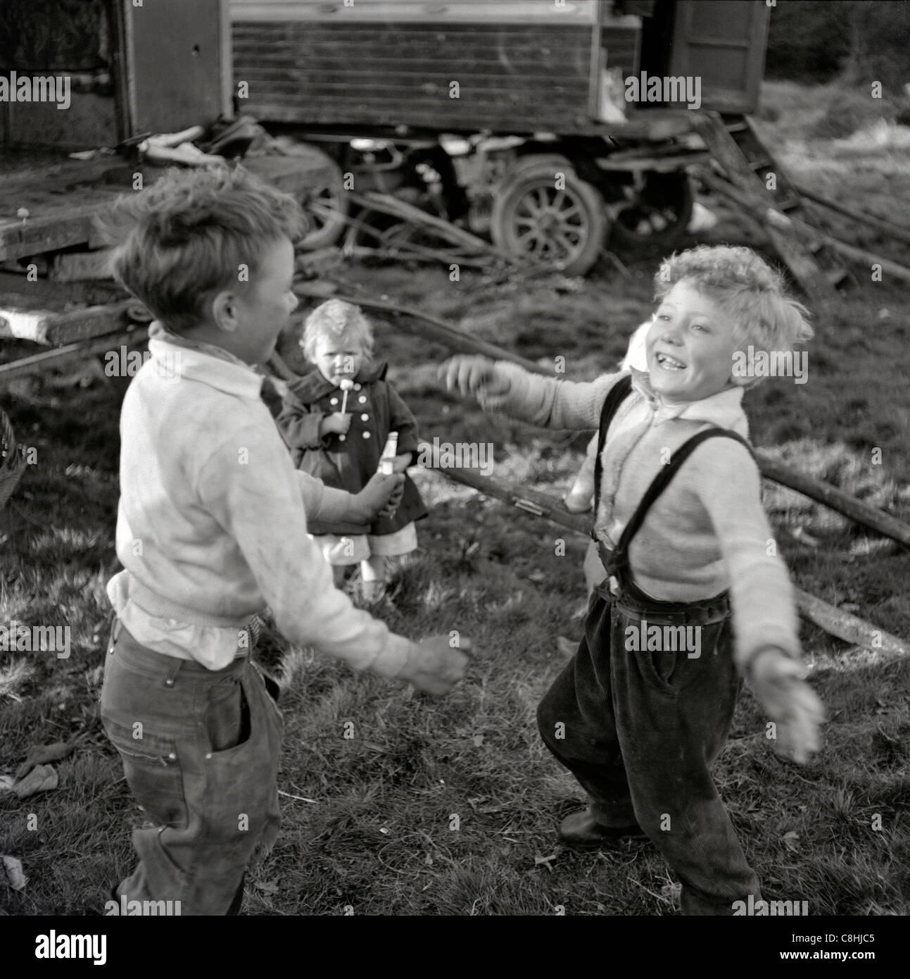 Romany Gypsy children playing in the yard in front of a Vardo in ...