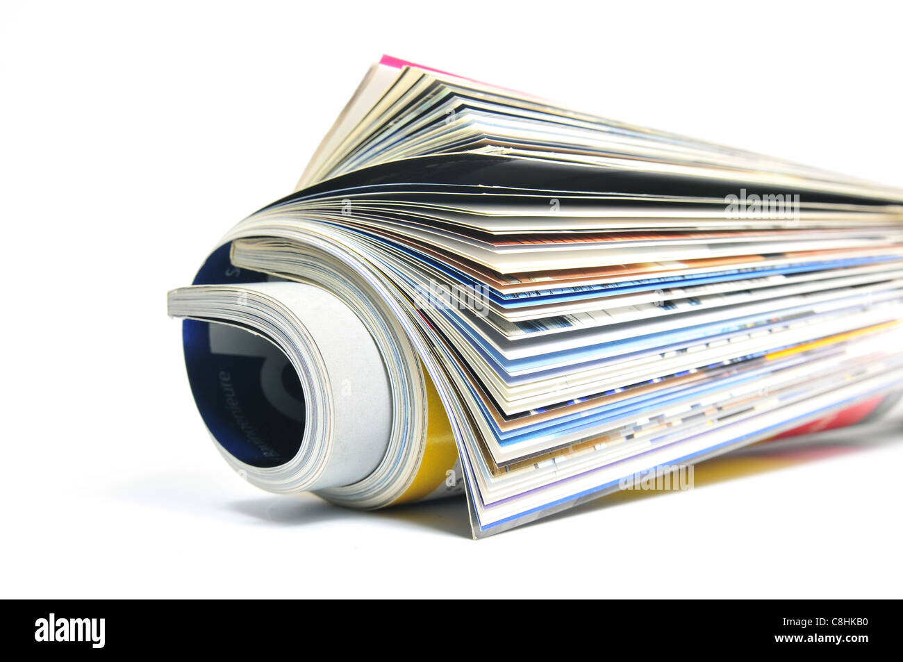 Rolled up magazine on white background Stock Photo - Alamy