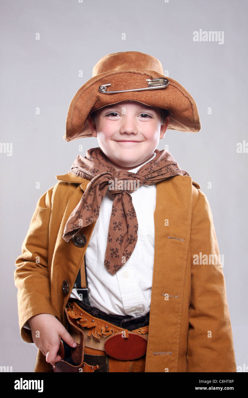 A young cowboy with a fake gun in the holster Stock Photo - Alamy