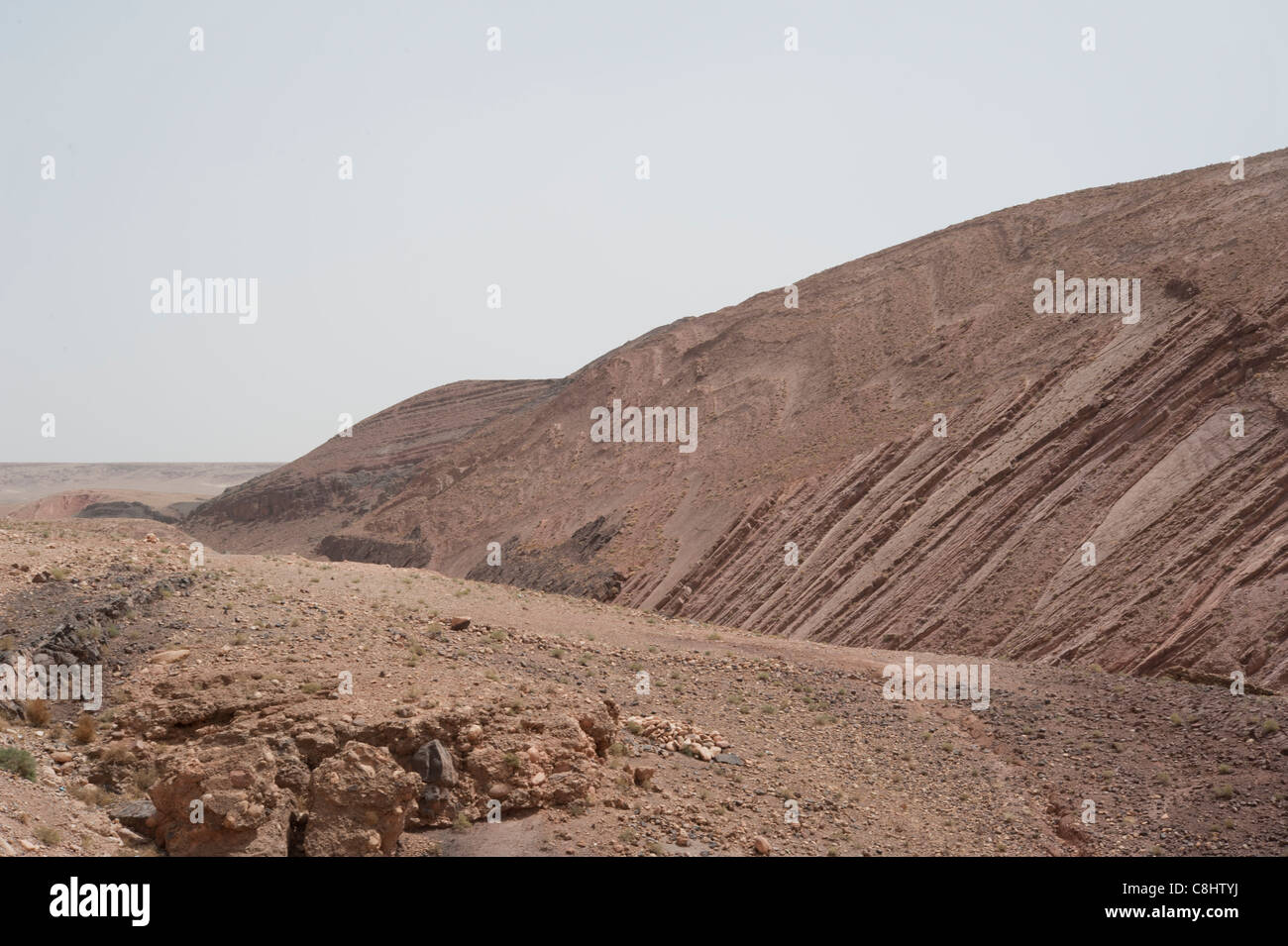 Steeply inclined rock strata in the Saharan desert near Ait Benhaddou ...