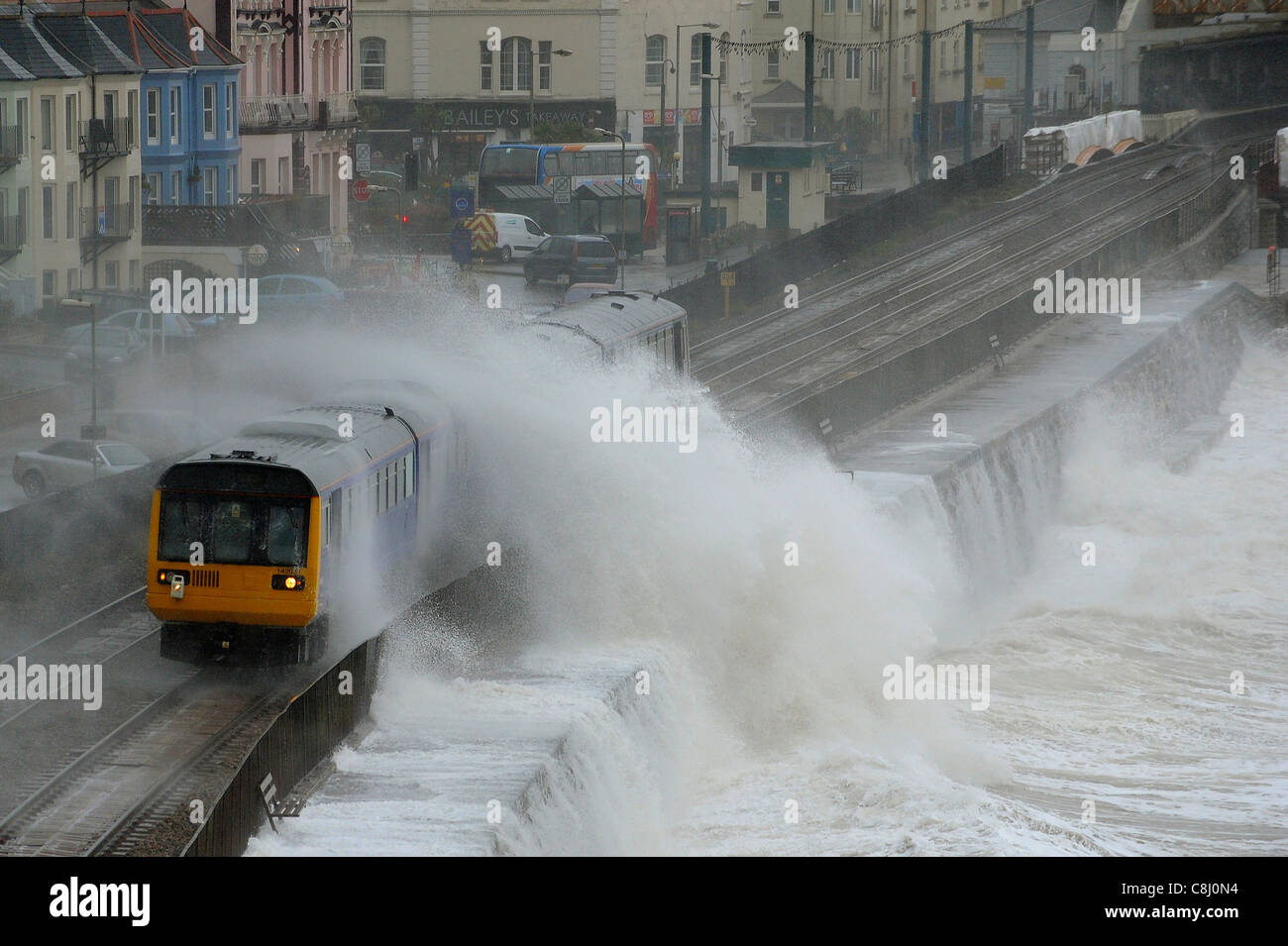 A train is battered by waves as it leaves the station at Dawlish in ...