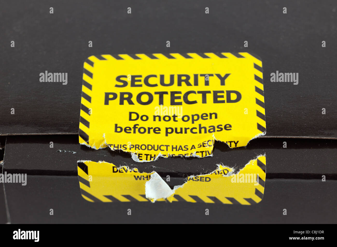 Broken security protected yellow label Stock Photo - Alamy