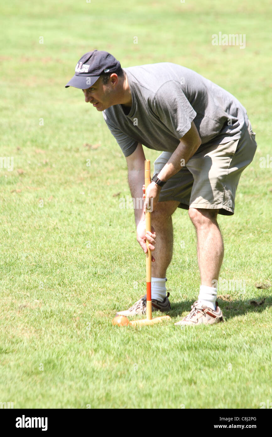 Croquet game playing in action sunny daytime July 4th party at park ...