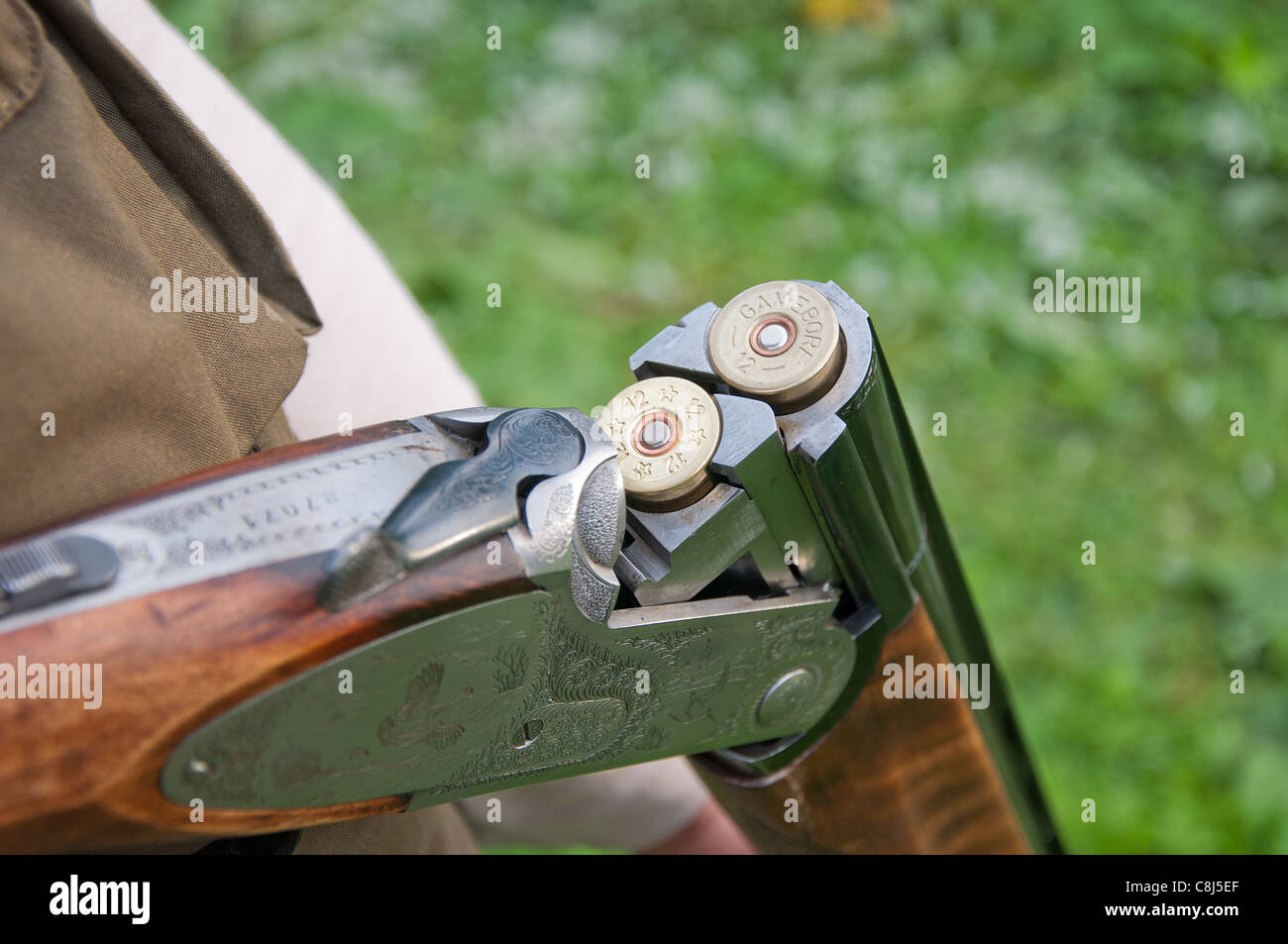 Person holding an Rizzini , over and under shotgun with the barrel in ...