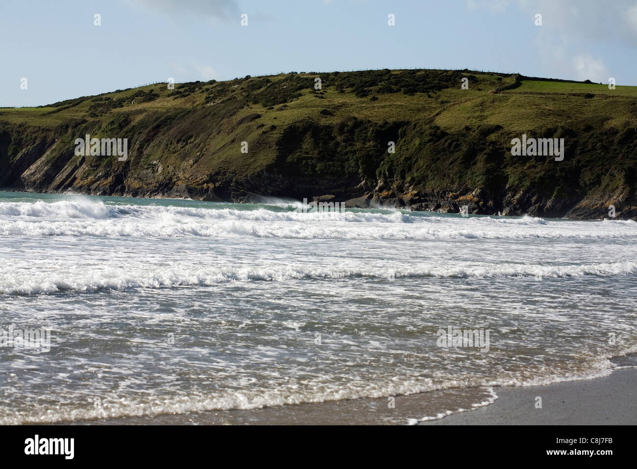 Waves coming ashore on the sandy beach at Aberdaron LLeyn Peninsula ...