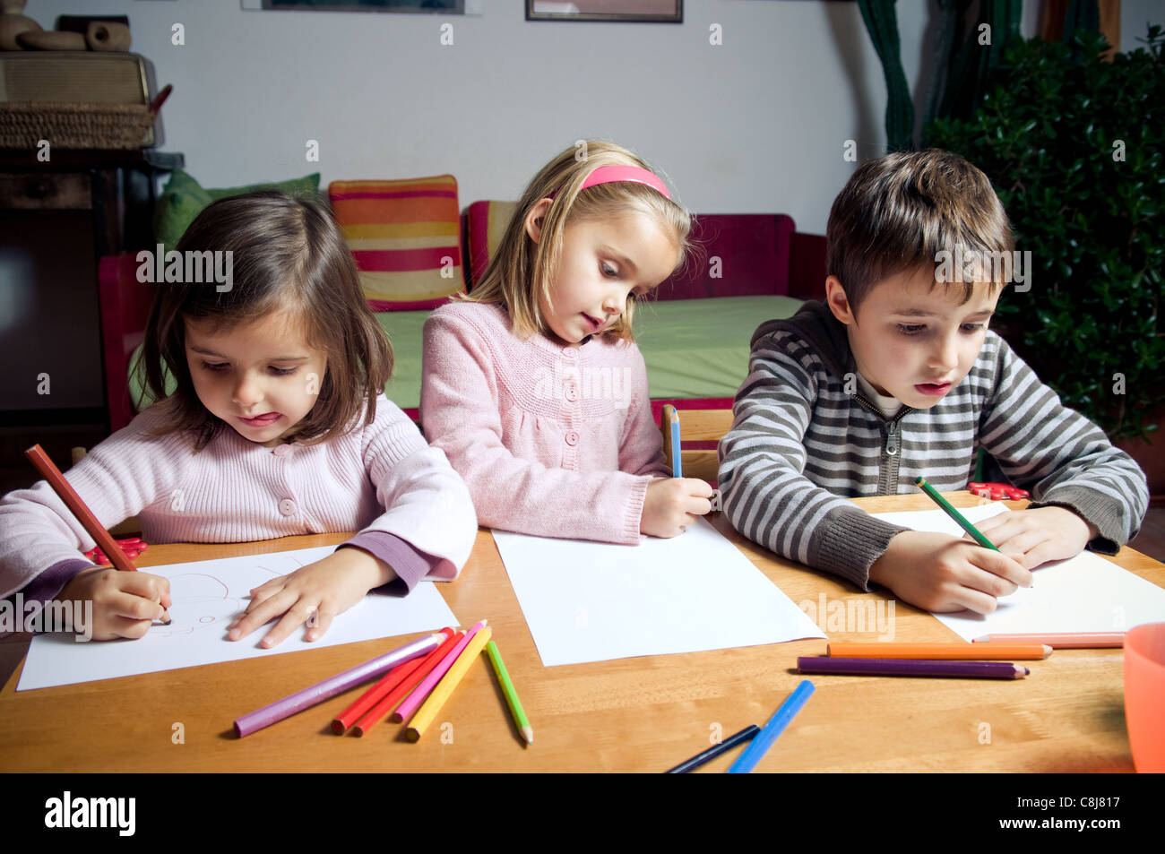 Kids drawing with crayons Stock Photo - Alamy