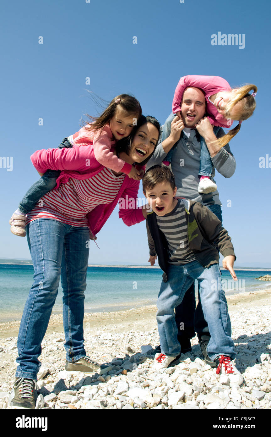 Happy family having fun by the sea Stock Photo - Alamy