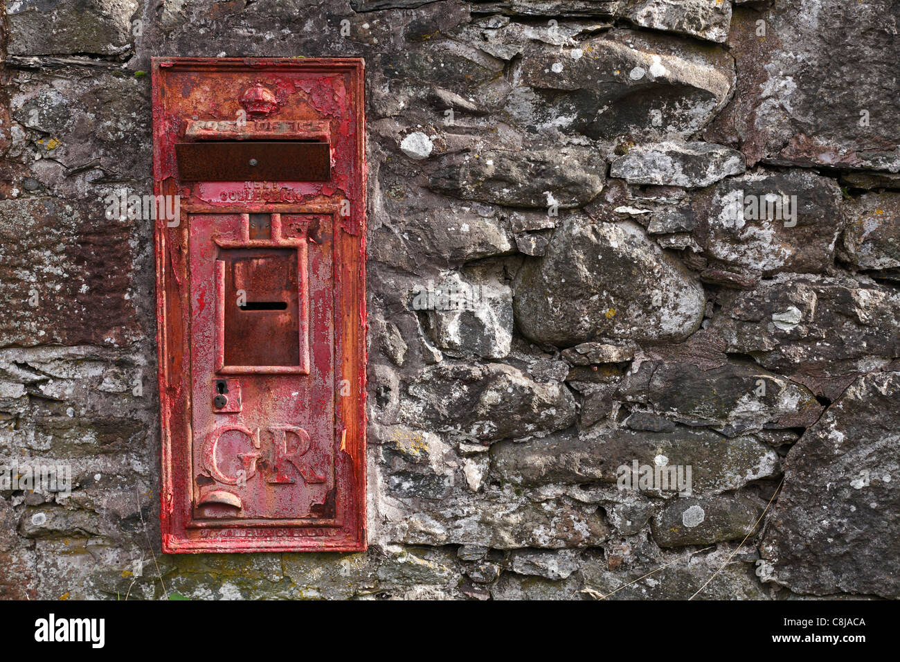 British red mailbox in old [stone wall], "Lake District", Cumbria ...
