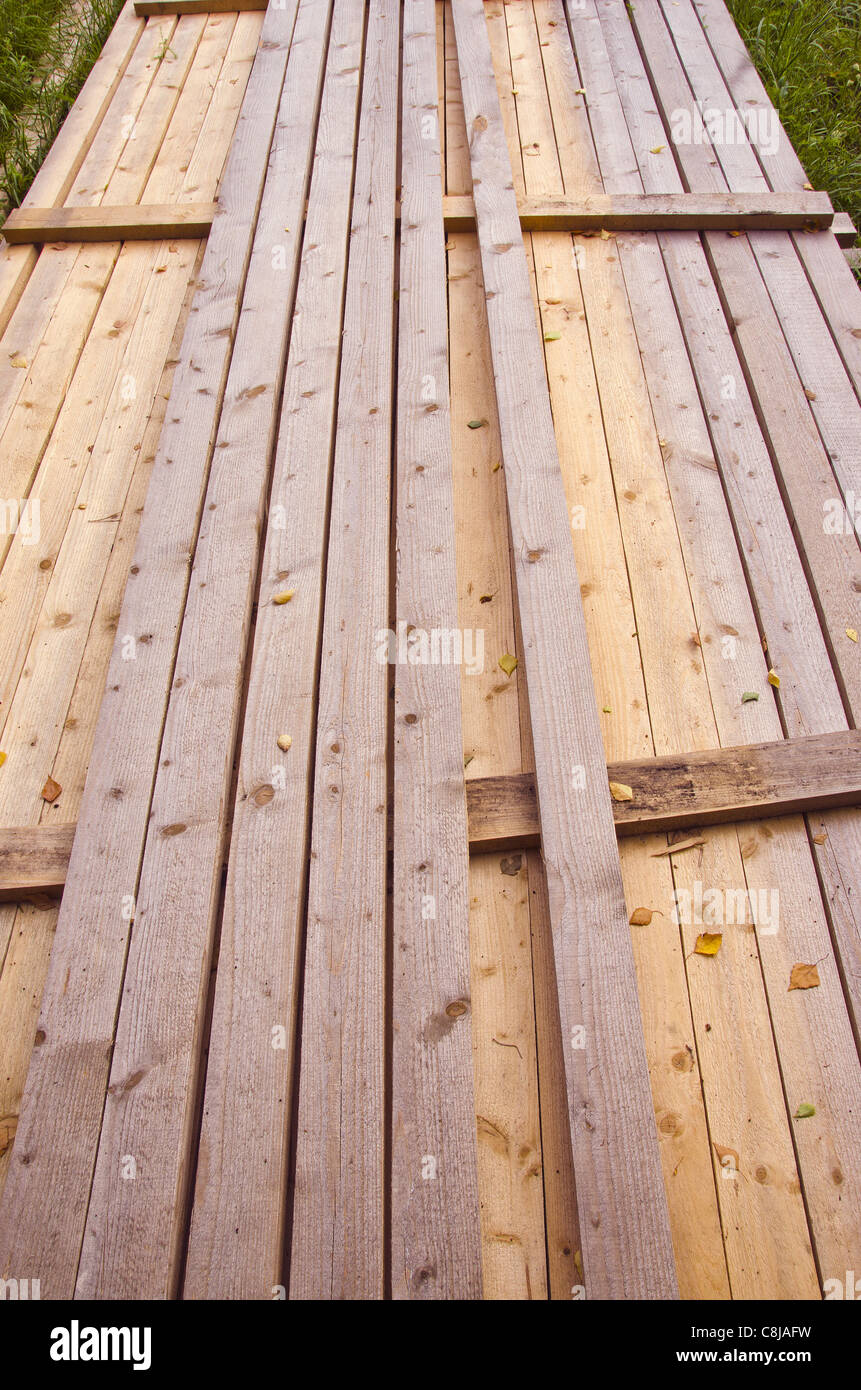 Many long wooden plank loaded in a bunch. Timber industry Stock Photo ...
