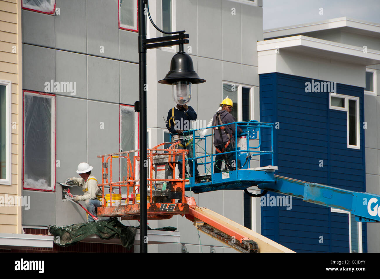 Men working in cherry pickers Stock Photo - Alamy