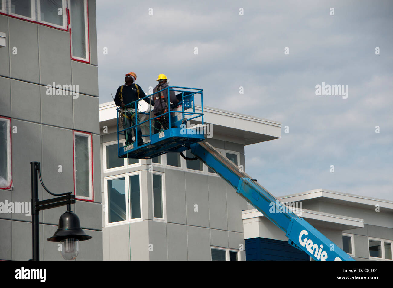 Men working in cherry pickers Stock Photo - Alamy