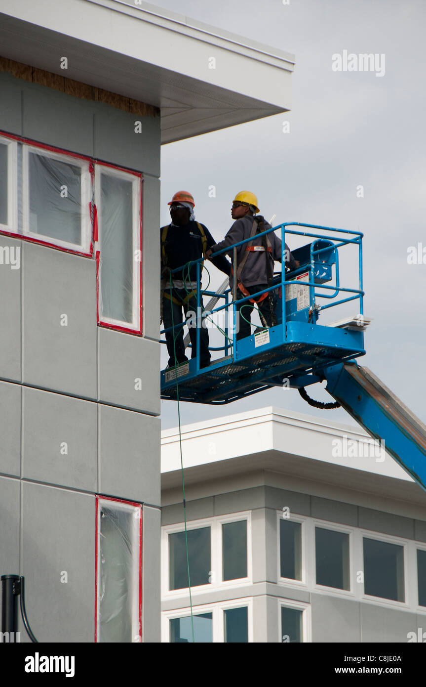 Men working in cherry pickers Stock Photo - Alamy