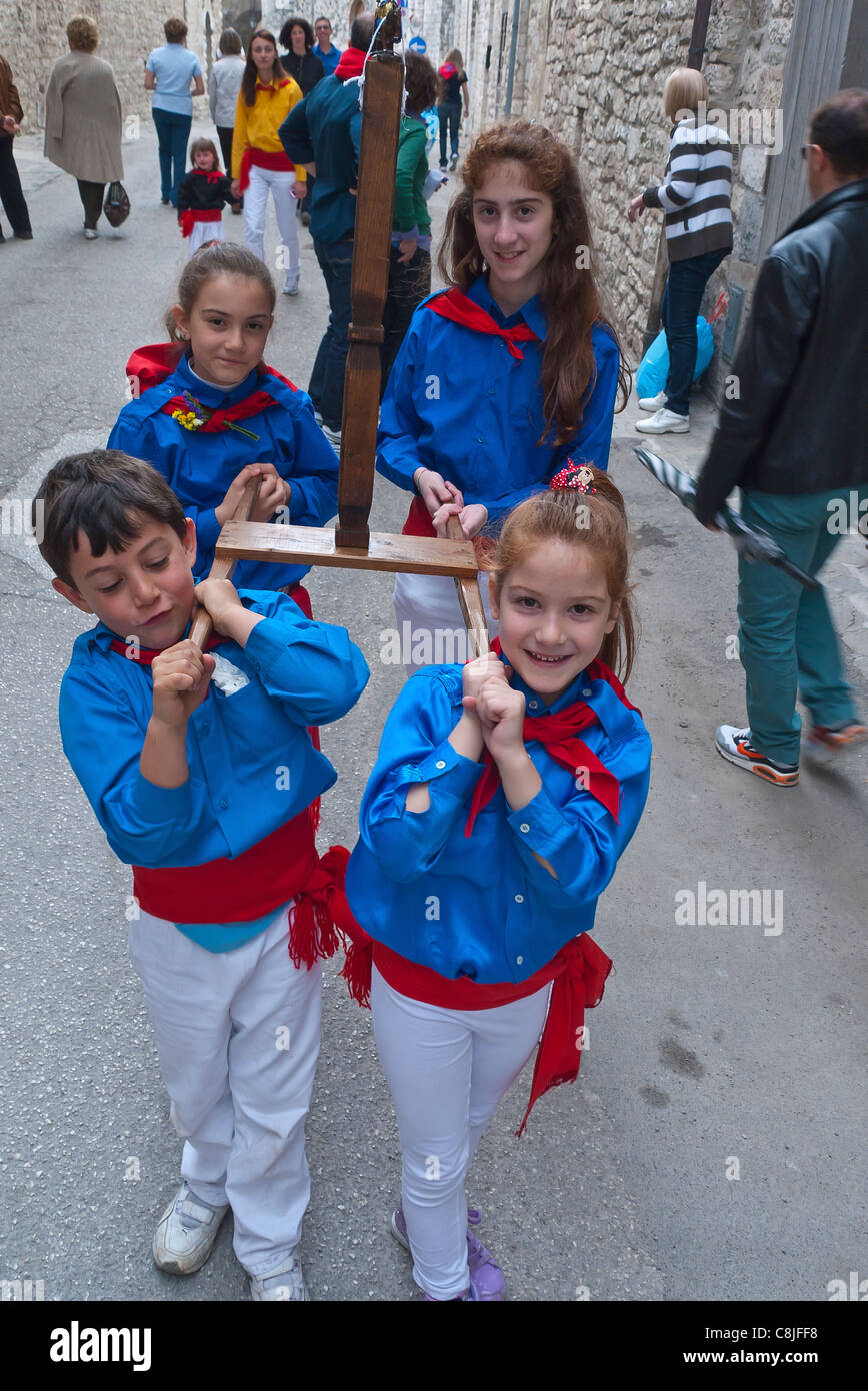 Four young children carry their version of the "stanga" (the H-shaped ...