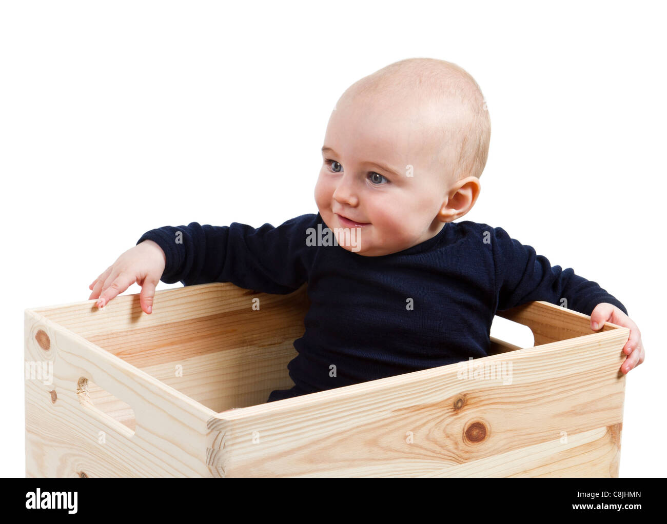 single toddler in wooden box looking to the left Stock Photo - Alamy