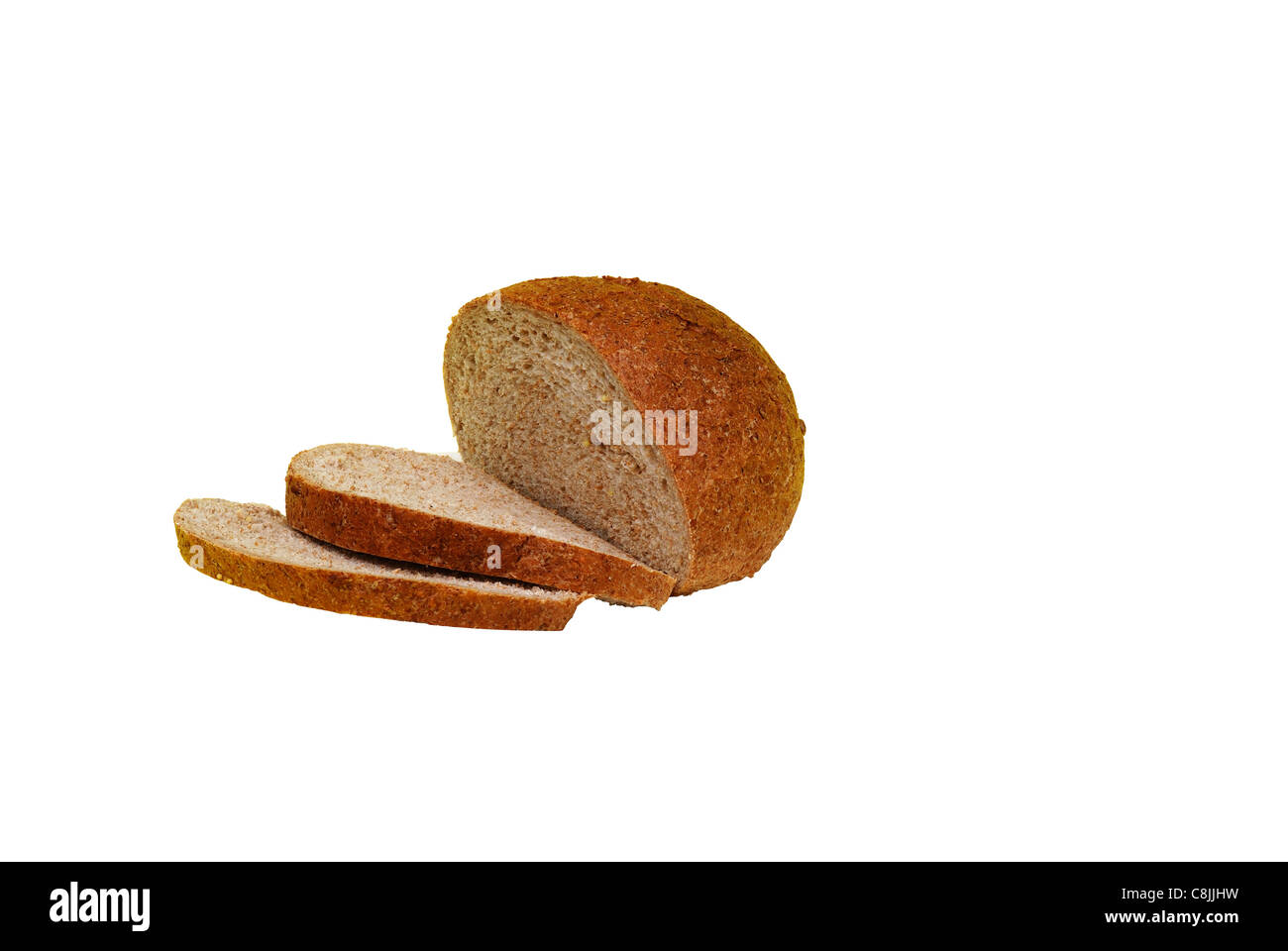 Small round loaf of brown granary bread with two slices on white ...