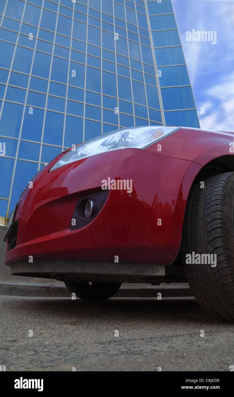 Red business car in front of a corporate building Stock Photo - Alamy