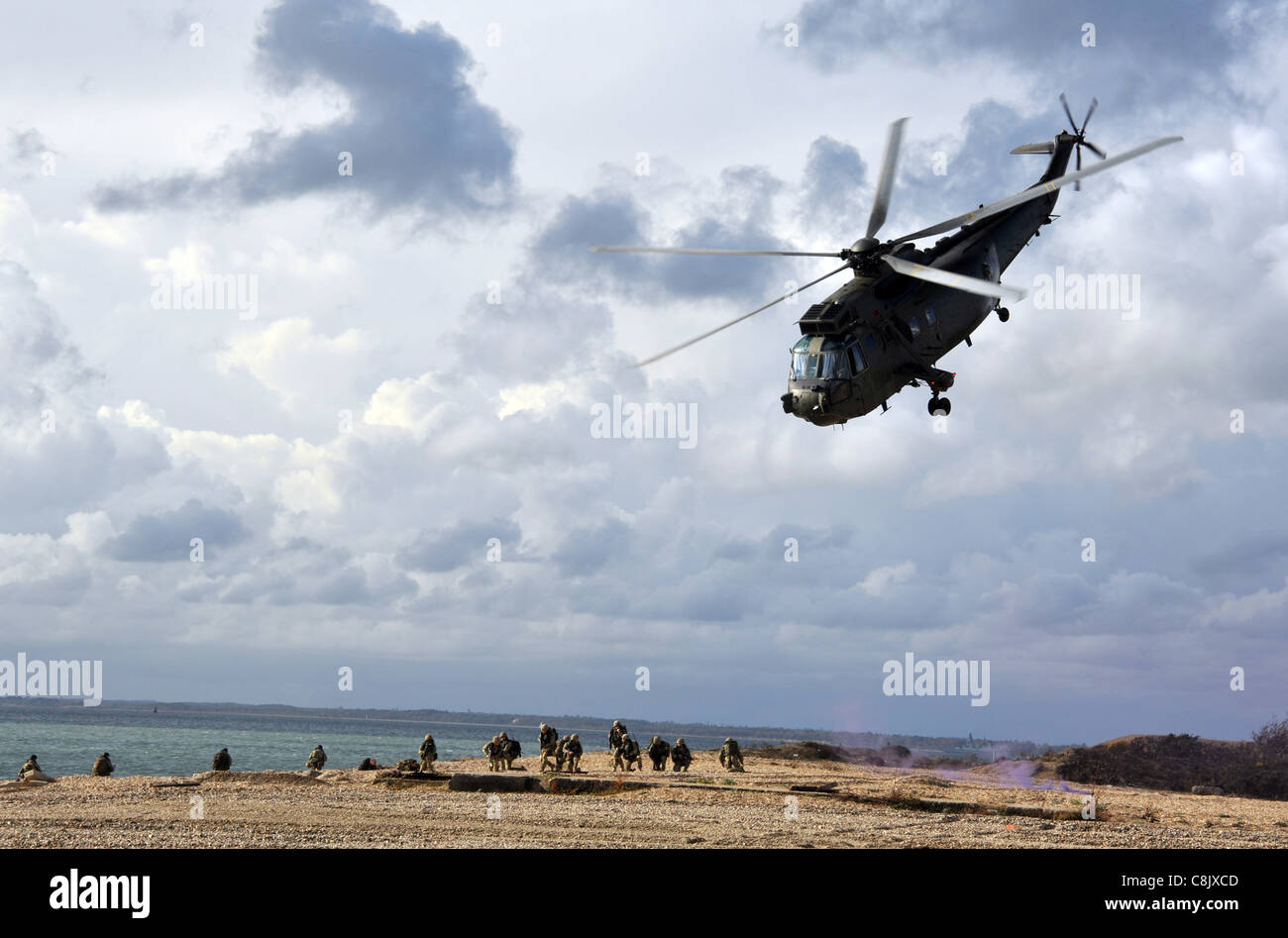 Royal Navy and Royal Marines beach assault. Sea King helicopter and ...