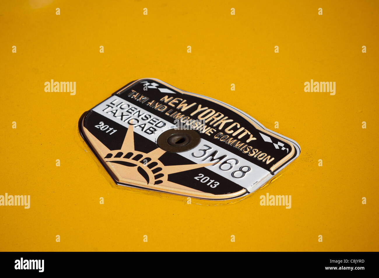 A NYC Taxi and Limousine Commission medallion on a cab Stock Photo - Alamy