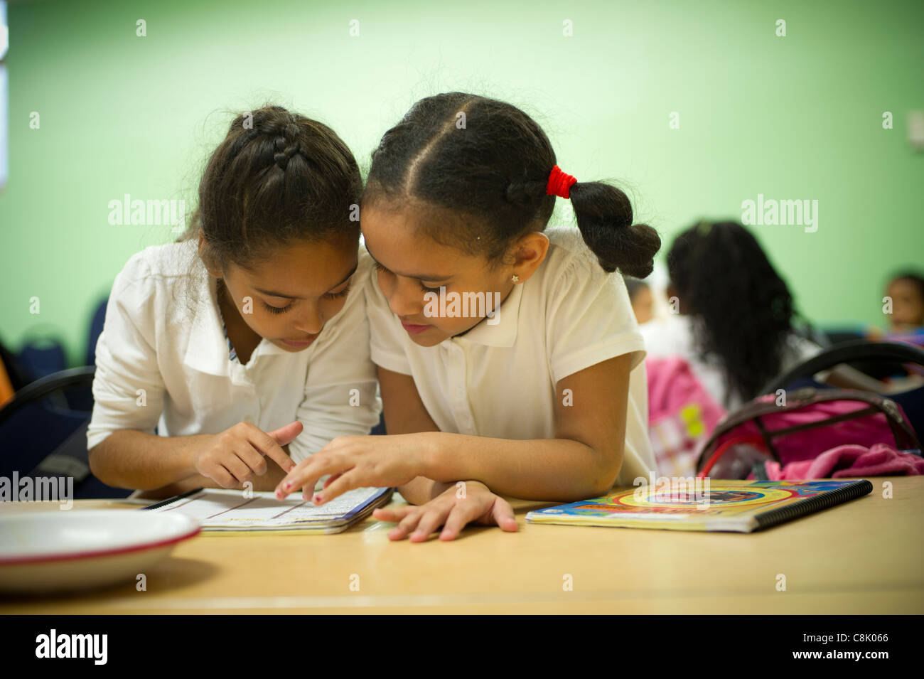 Second and third graders do homework during an after school program in ...